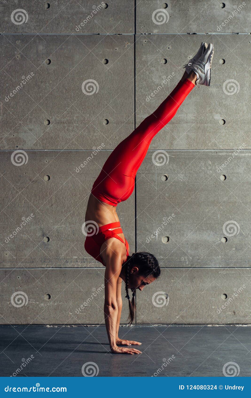 Young Fit Woman Doing Handstand Exercise in Studio. Stock Photo - Image ...