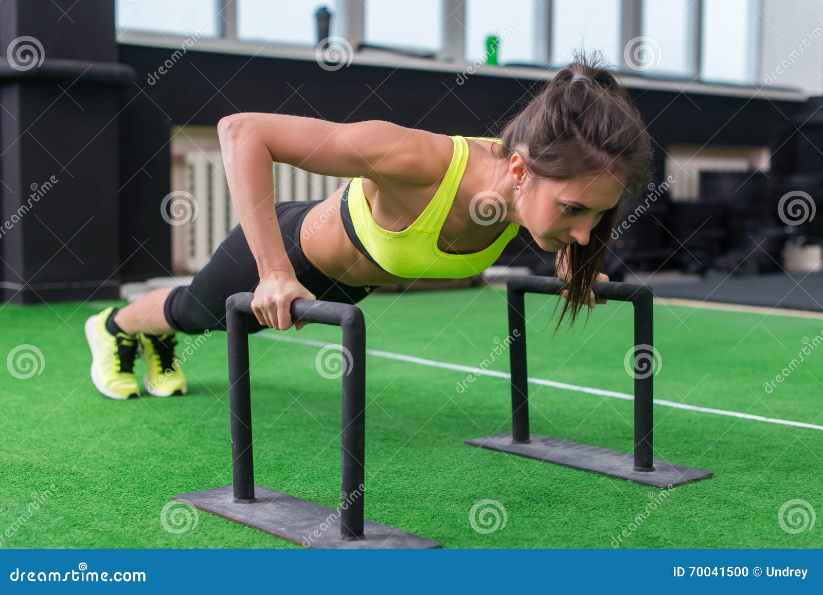 Young Fit Woman Doing Horizontal Push-ups with Bars in Gym. Stock Photo ...