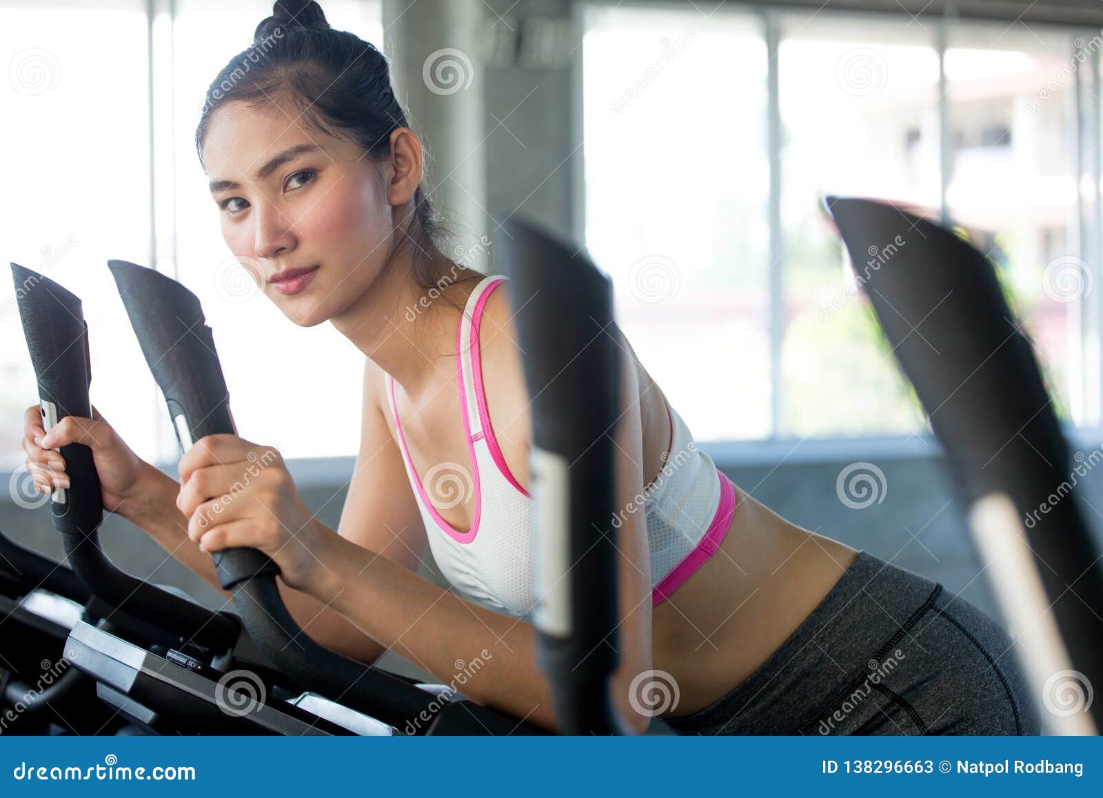 Asian Young Fitness Woman In Sportswear Exercising With Biking In Sport