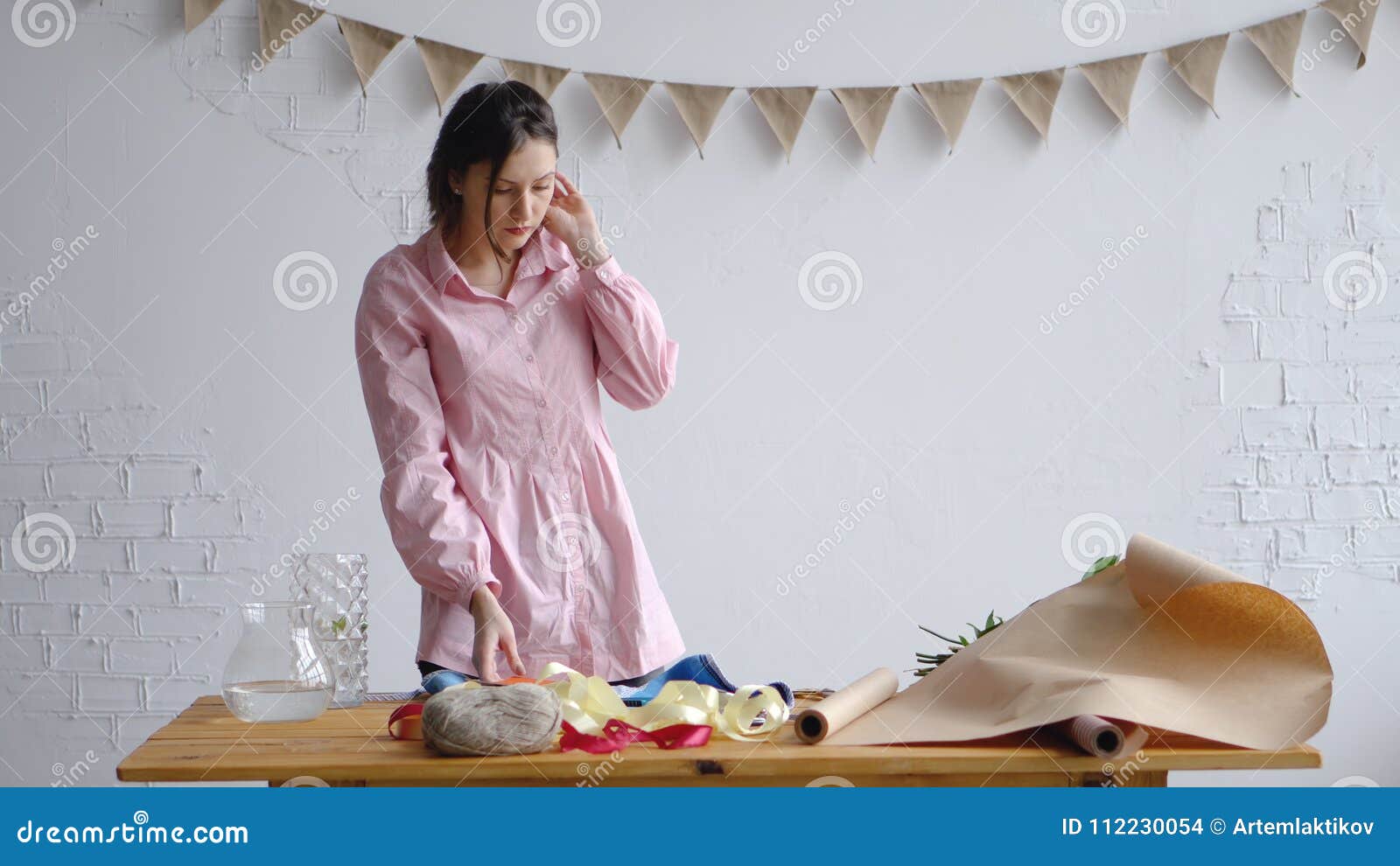 A Young Florist Prepares a Workstation To Create a Bouquet Stock Photo ...
