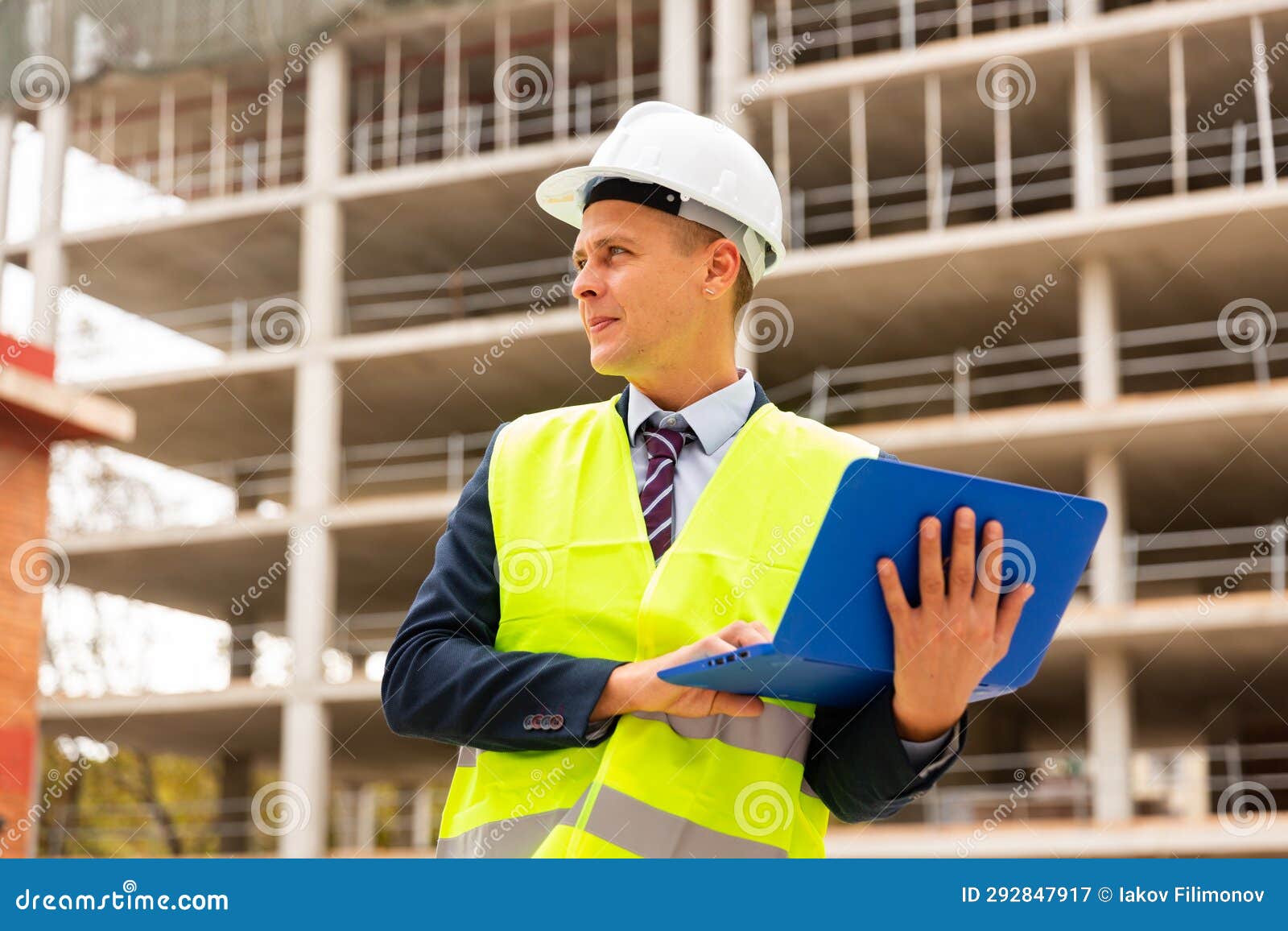 Young Focused Engineer Controlling the Progress of Work on a Laptop ...