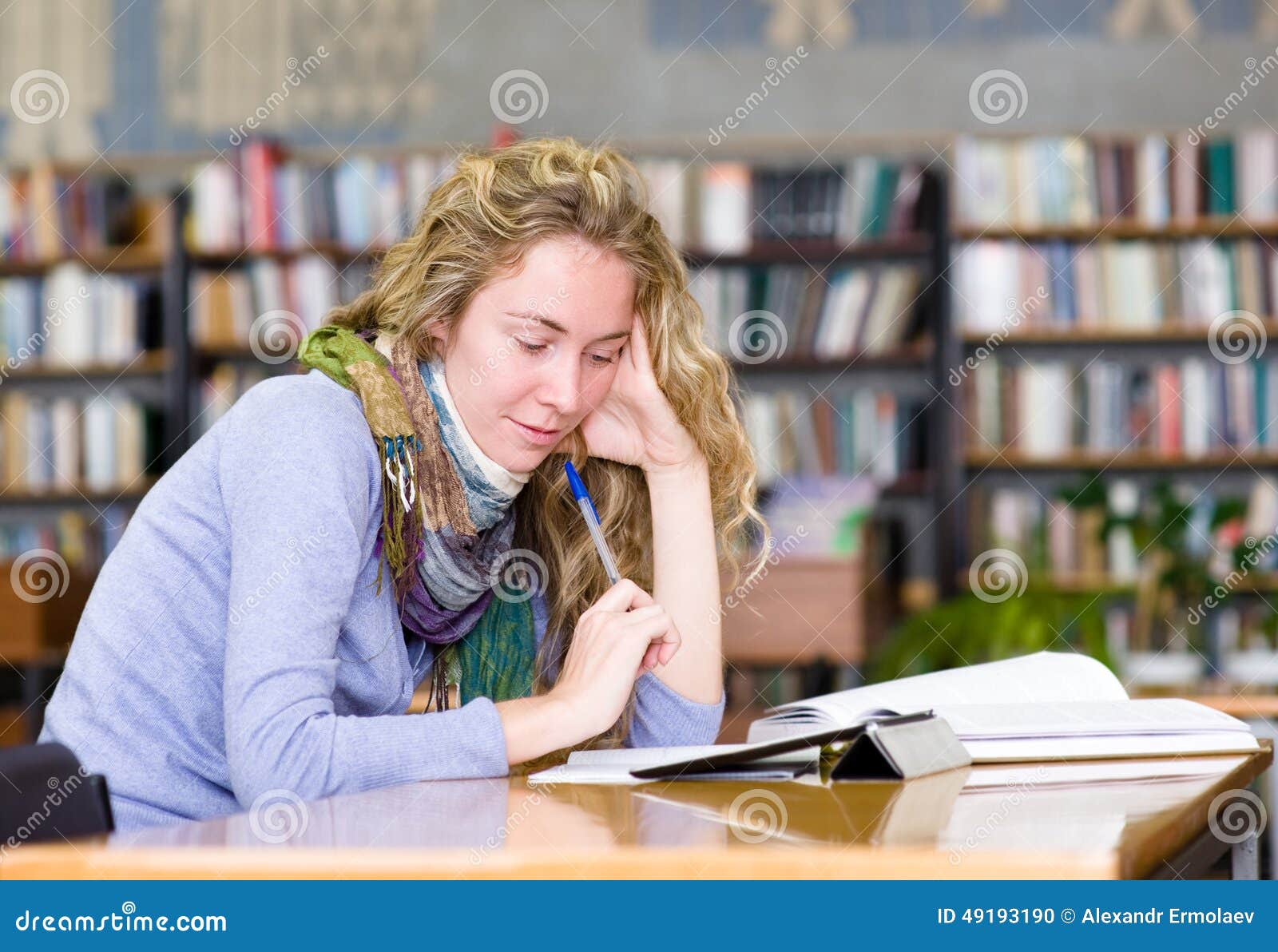 Young Focused Student Using a Tablet Computer in a Library Stock Photo ...