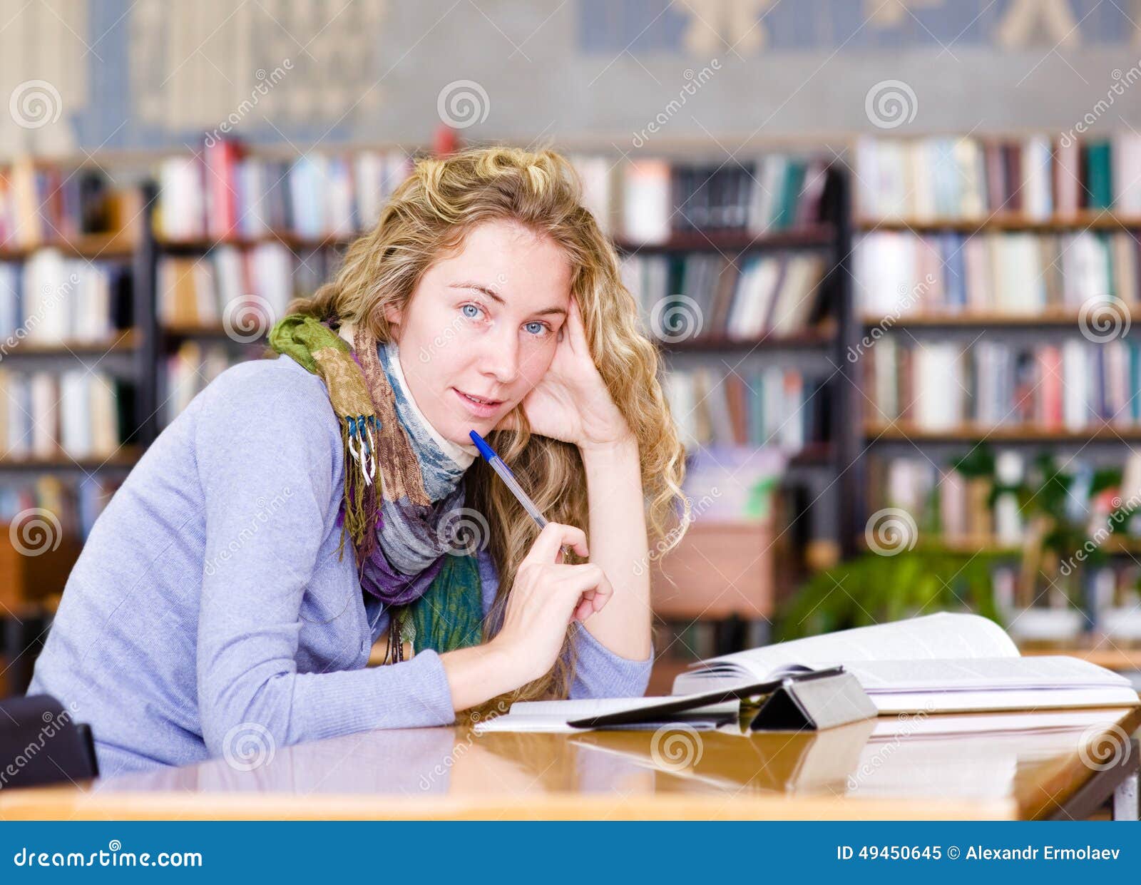 Young Focused Student Using a Tablet Computer in a Library Stock Image ...