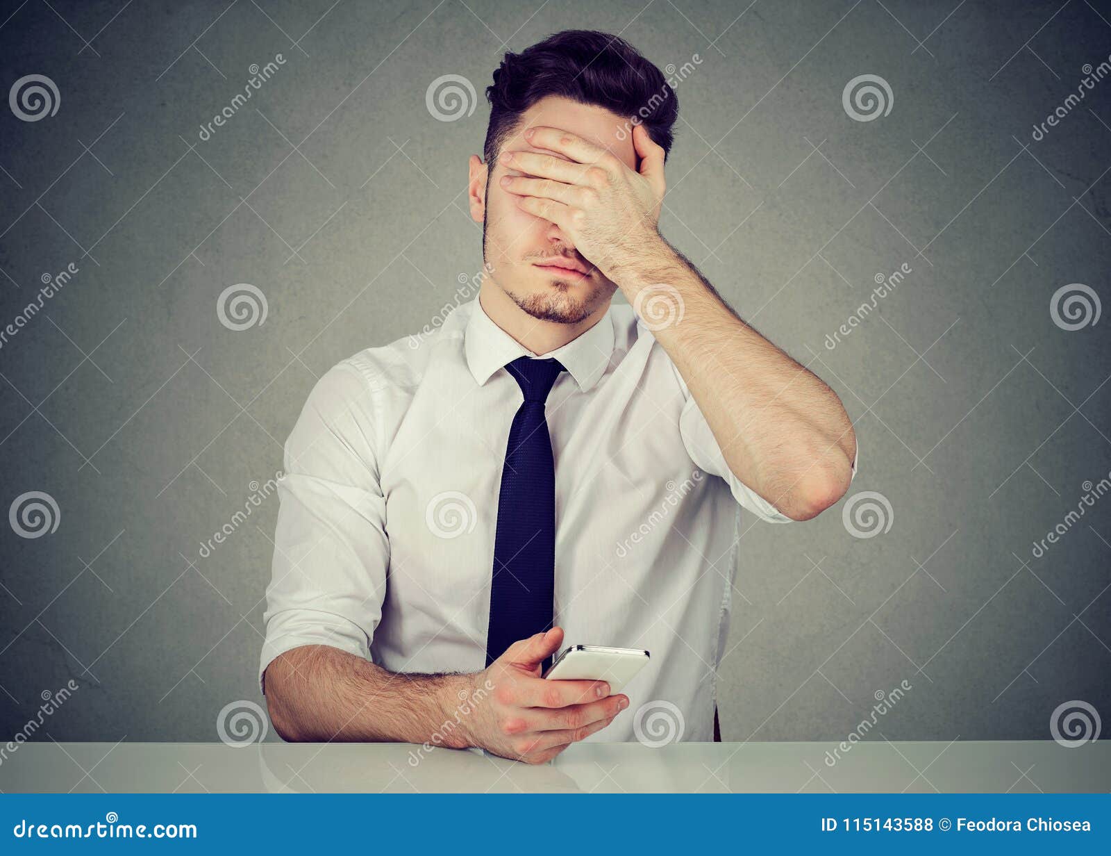 Man with Phone Covering Face in Despair Stock Photo - Image of face ...