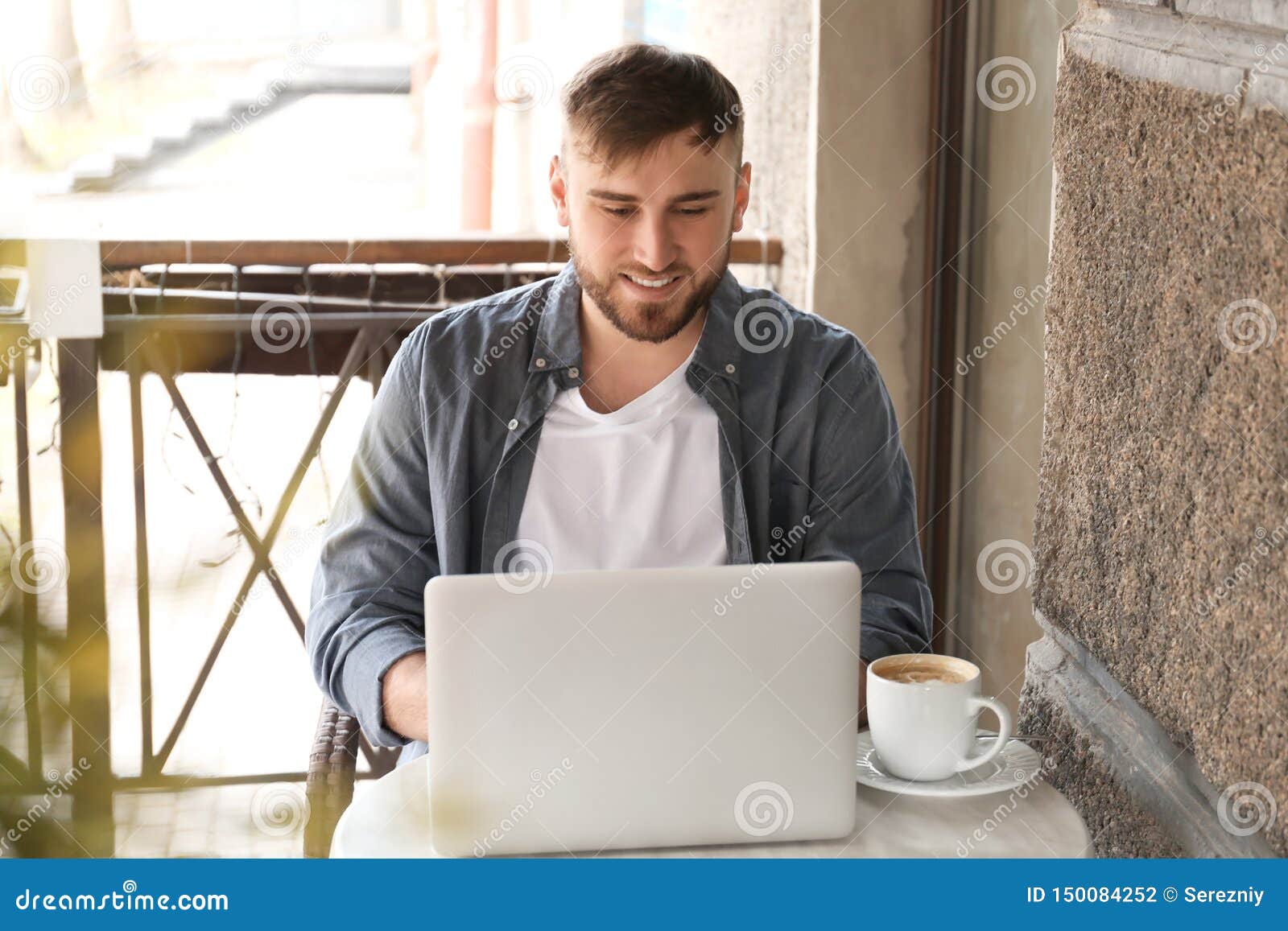 Young Freelancer with Laptop Working in Cafe Stock Photo - Image of ...