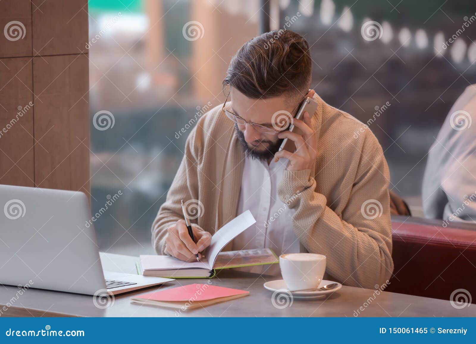 Young Freelancer with Mobile Phone and Laptop Working in Cafe Stock ...