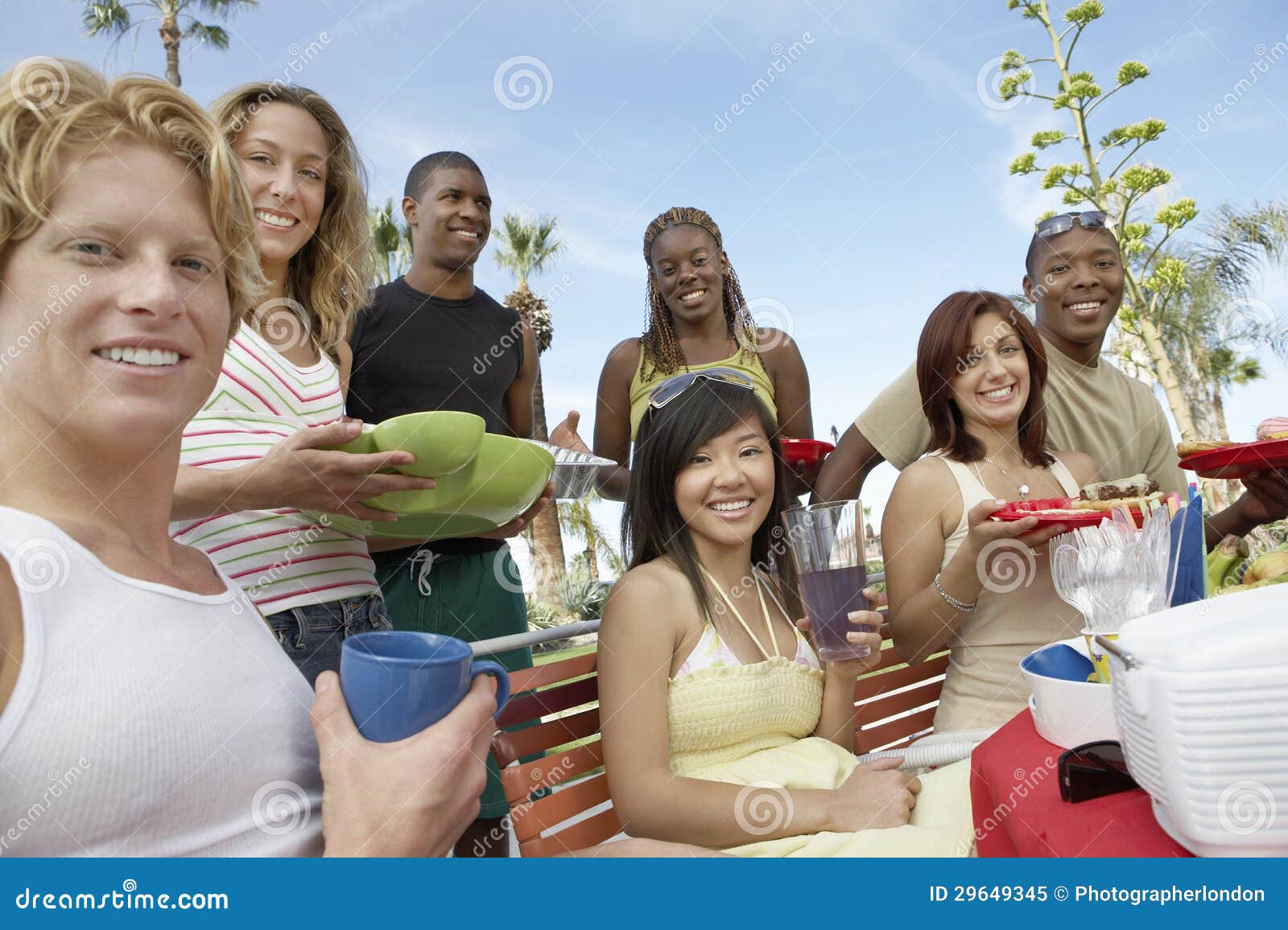 Young Friends Eating Together Stock Image - Image of picnic, outdoors ...