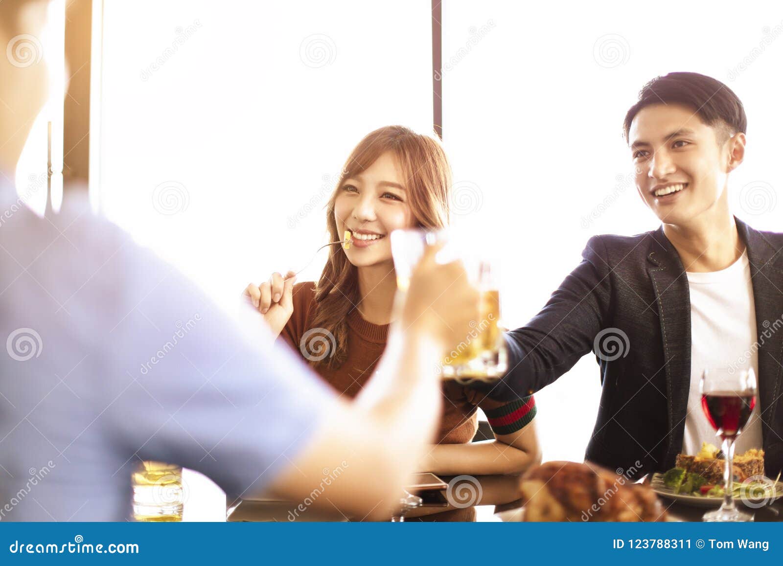 Young Friends Enjoy Dinner in Restaurant. Stock Image - Image of beer ...