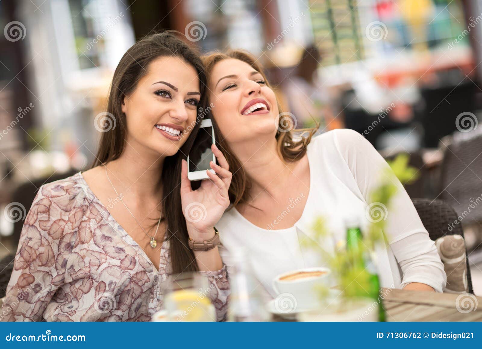 Young Friends Laughing while Drinking Coffee Stock Photo - Image of ...