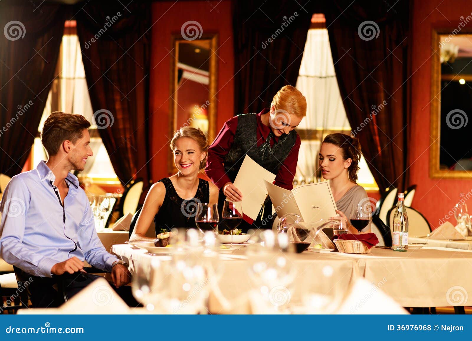 Young Friends in a Luxury Restaurant Stock Photo - Image of choosing ...