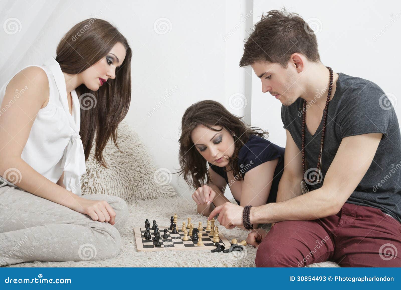 Young Friends Playing Chess on Sofa Stock Image - Image of lifestyle ...