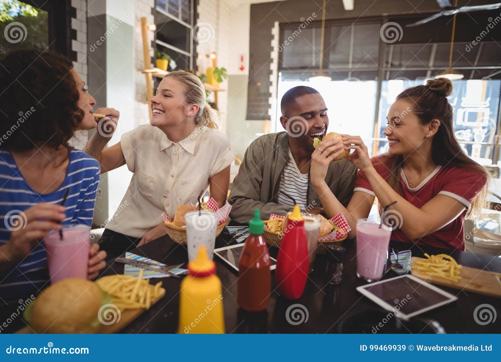 Young Friends Sharing Food at Coffee Shop Stock Image - Image of coffee ...