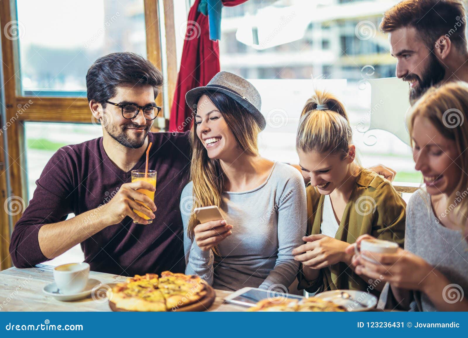 Young Friends Sharing Pizza in a Cafe Stock Image - Image of holding ...