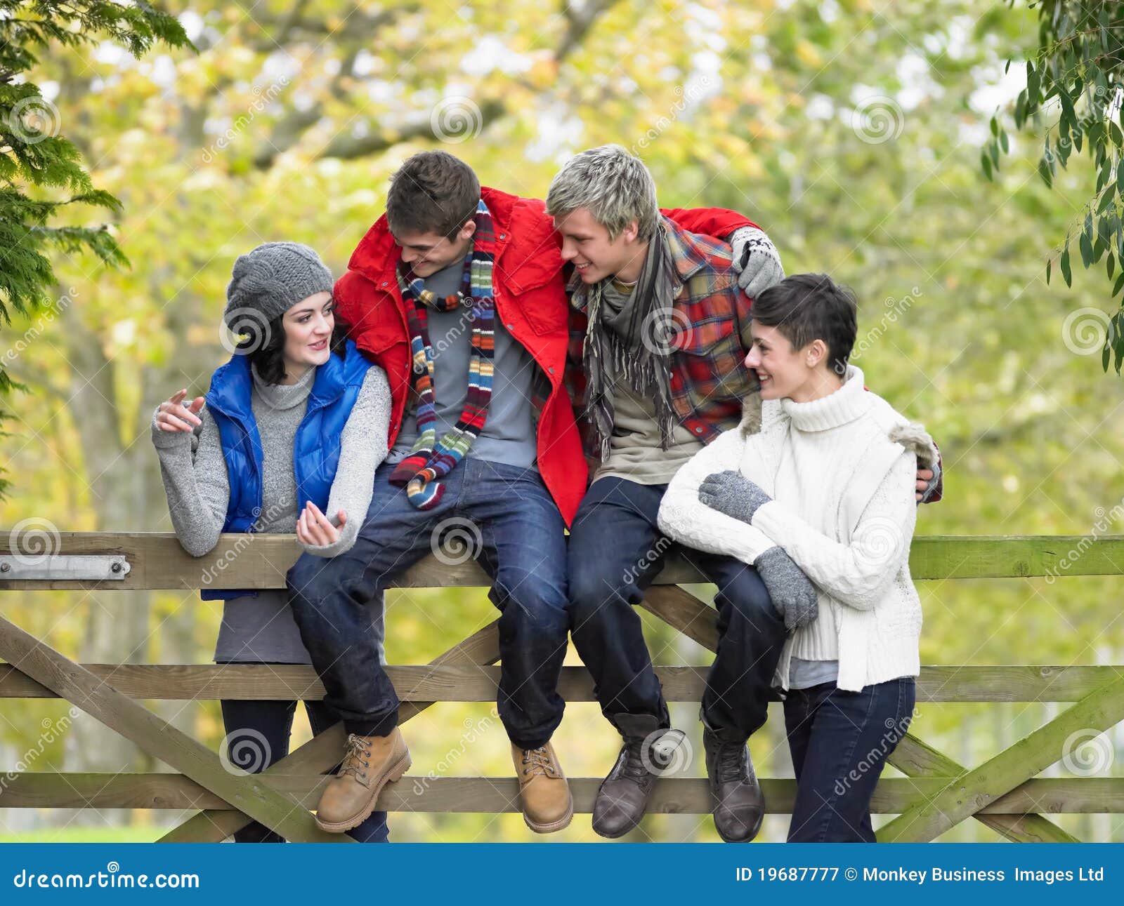Young Friends Sitting on Fence Stock Image - Image of sitting ...