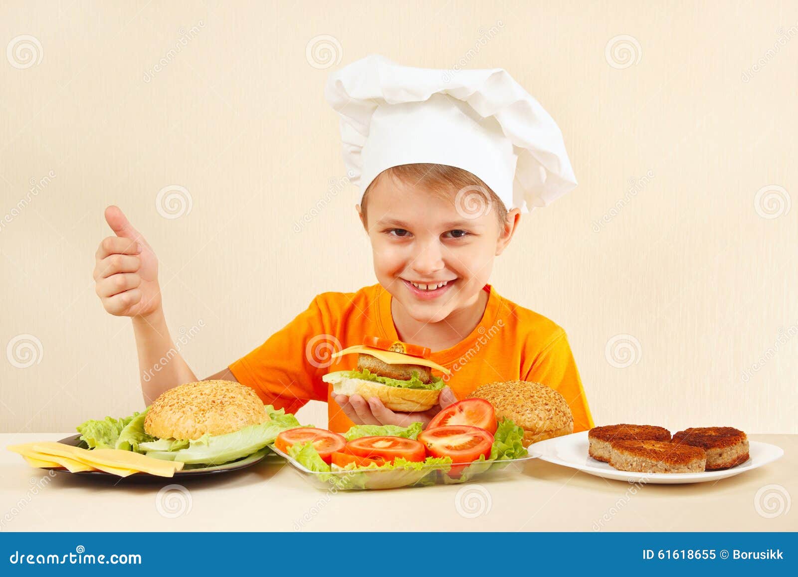 Young Funny Boy in Chefs Hat Shows How To Cook Hamburger Stock Image ...