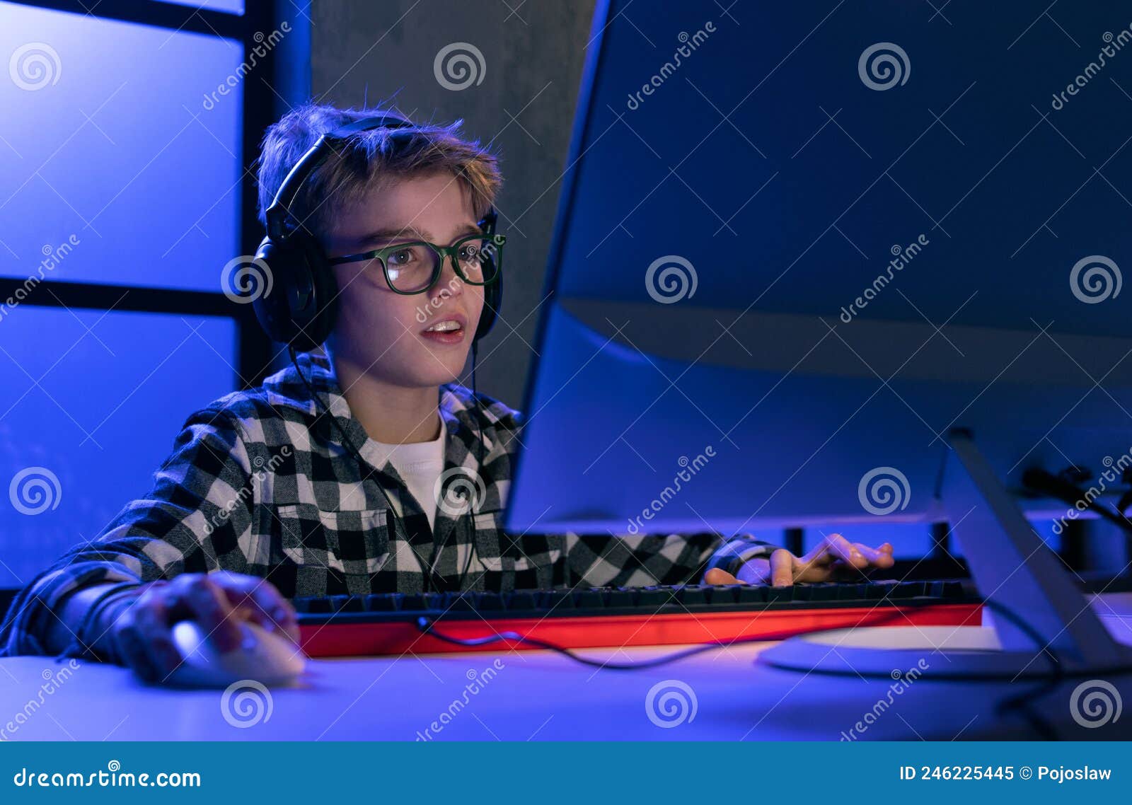Young Gamer Boy with Headphones Playing Computer Video Game. Stock ...