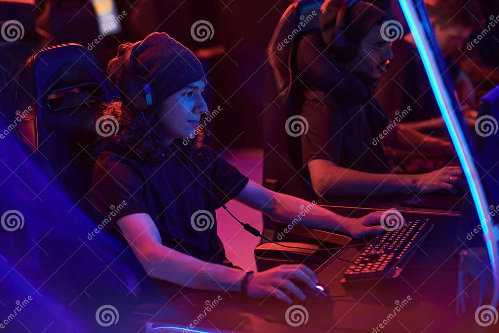 Young Gamer Interacting with Team in Online Game Stock Photo - Image of ...
