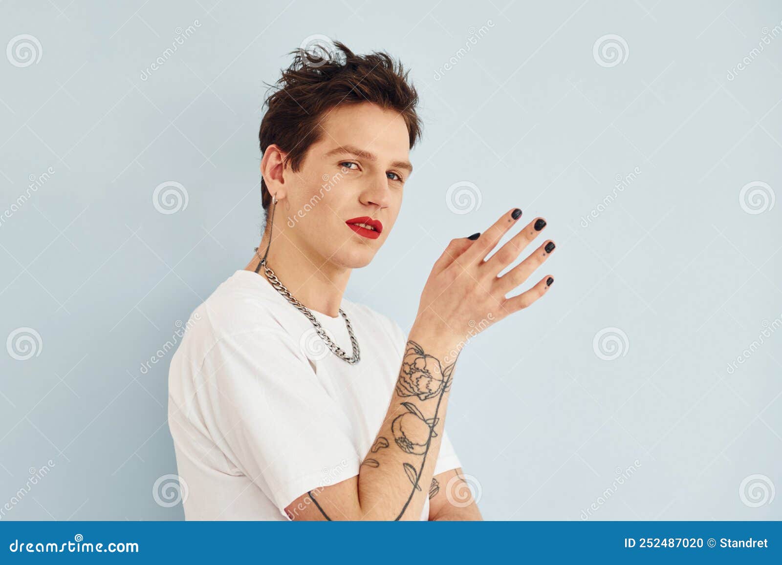 Young Gay Man is Standing in the Studio and Posing for a Camera. Lips ...
