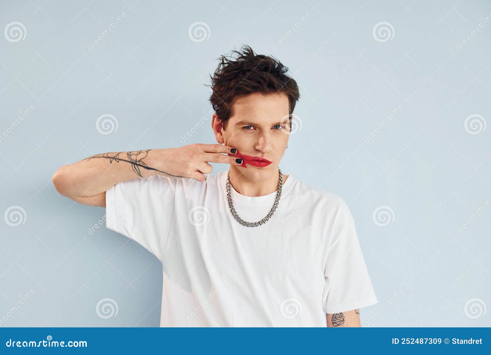 Young Gay Man is Standing in the Studio and Posing for a Camera. Lips ...