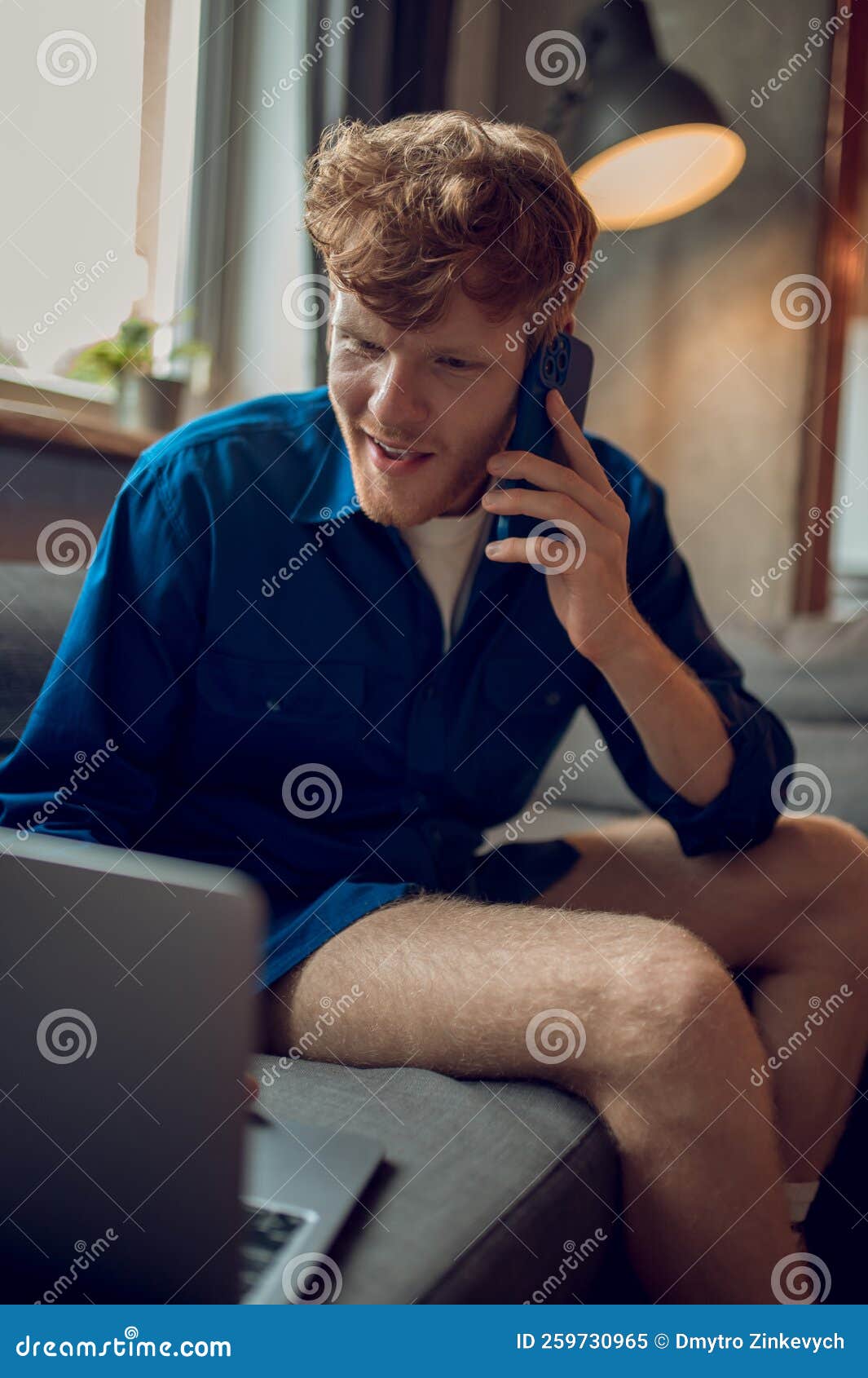 A Young Ginger Man Talking on the Phone and Looking Involved Stock ...