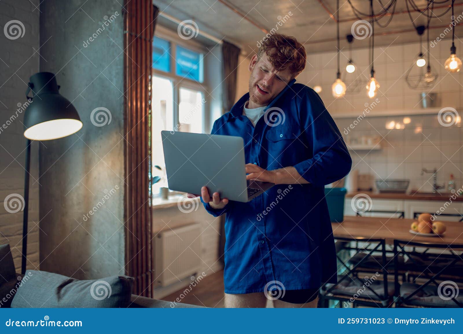 A Young Ginger Man Talking on the Phone and Looking Involved Stock ...