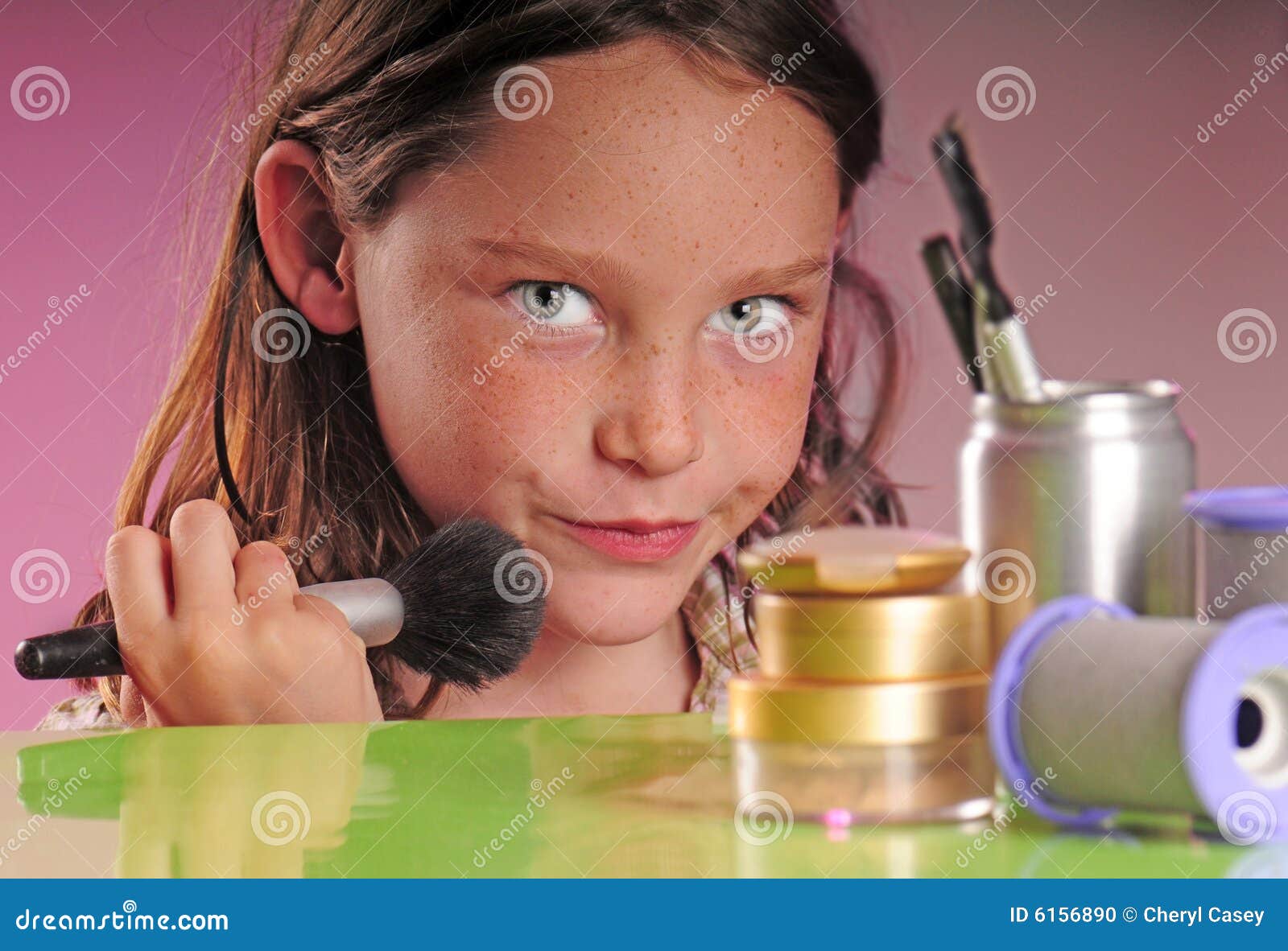 Young girl applying makeup stock photo. Image of brush - 6156890