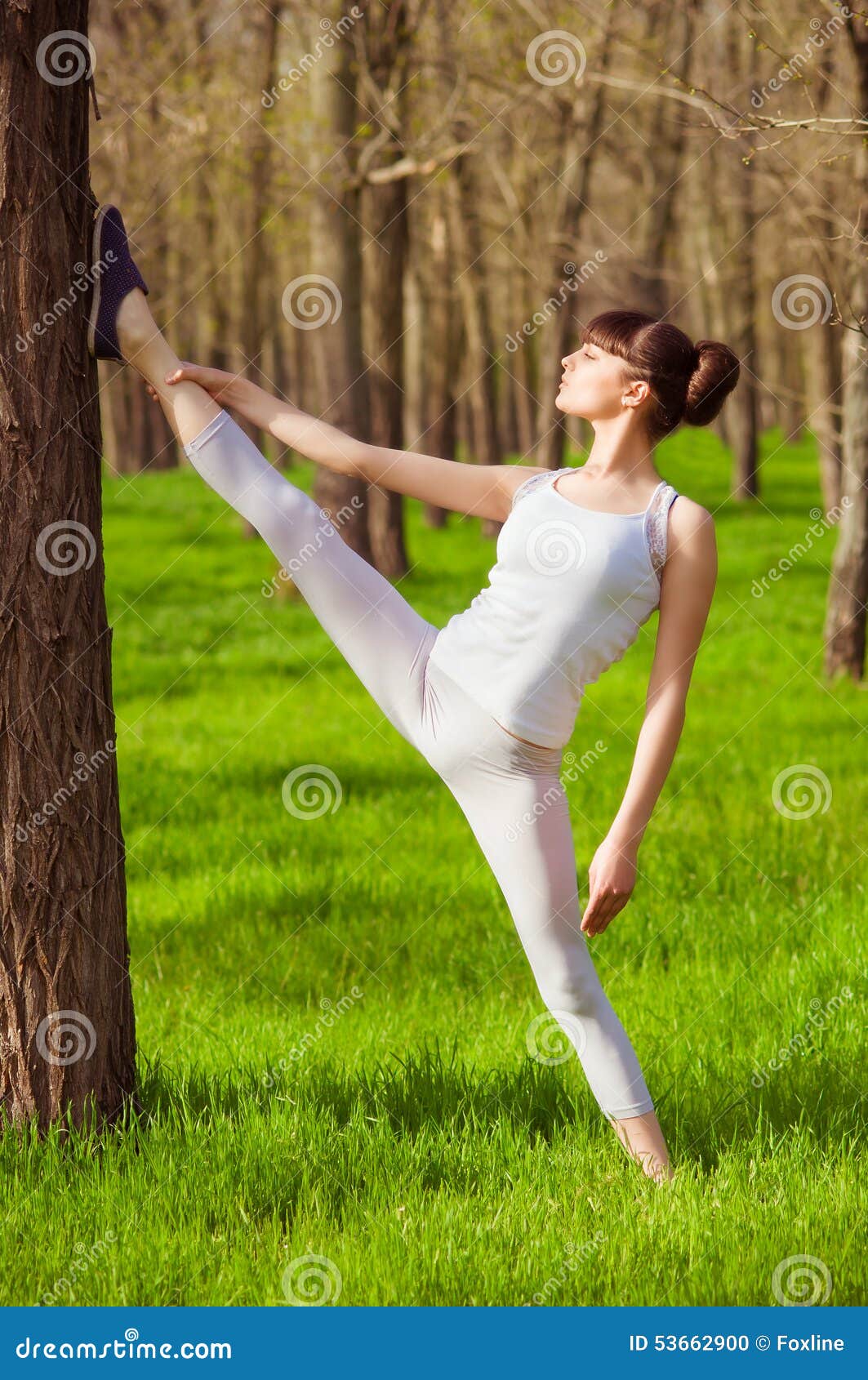 Young Girl Athlete Doing Stretching in a Tree on the Grass Stock Photo ...