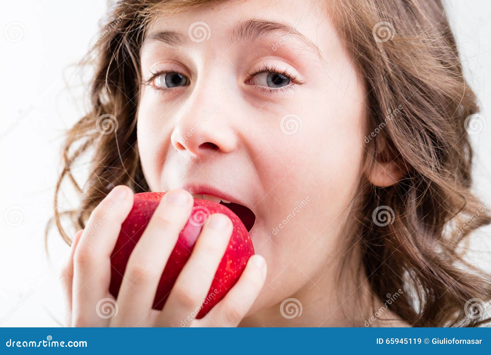 Young Girl Biting into Apple Stock Image - Image of apple, holding ...