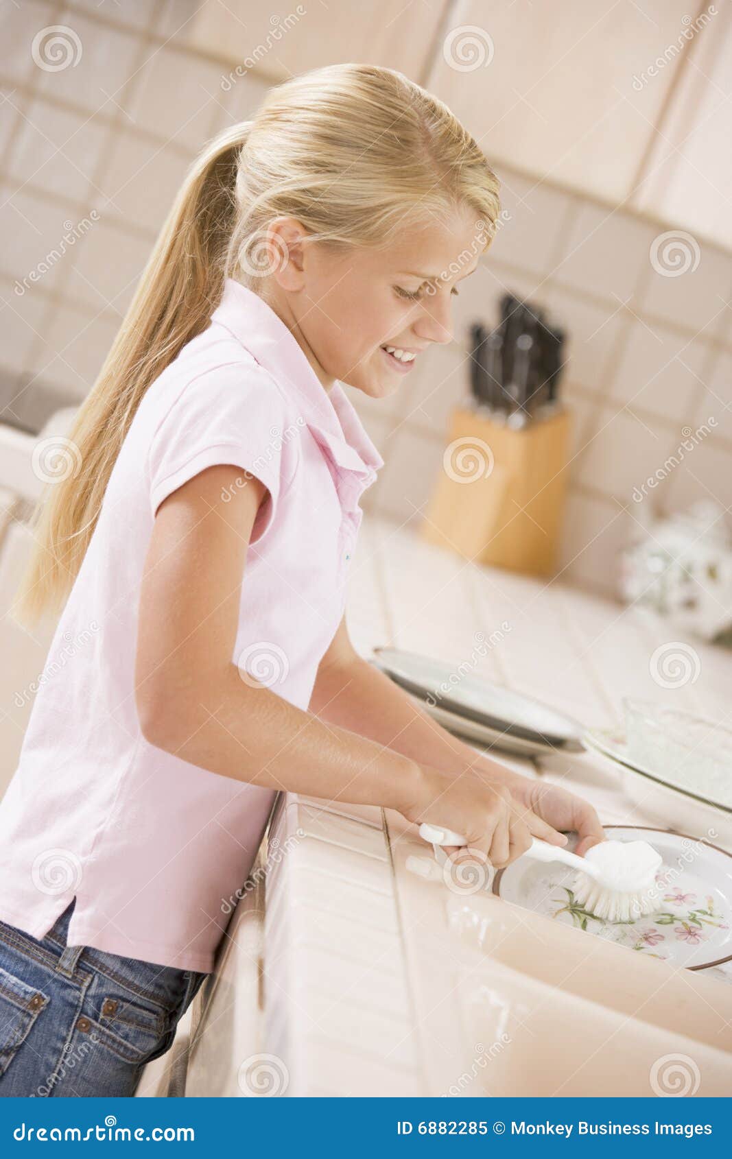 Young Girl Cleaning Dishes stock image. Image of holding - 6882285