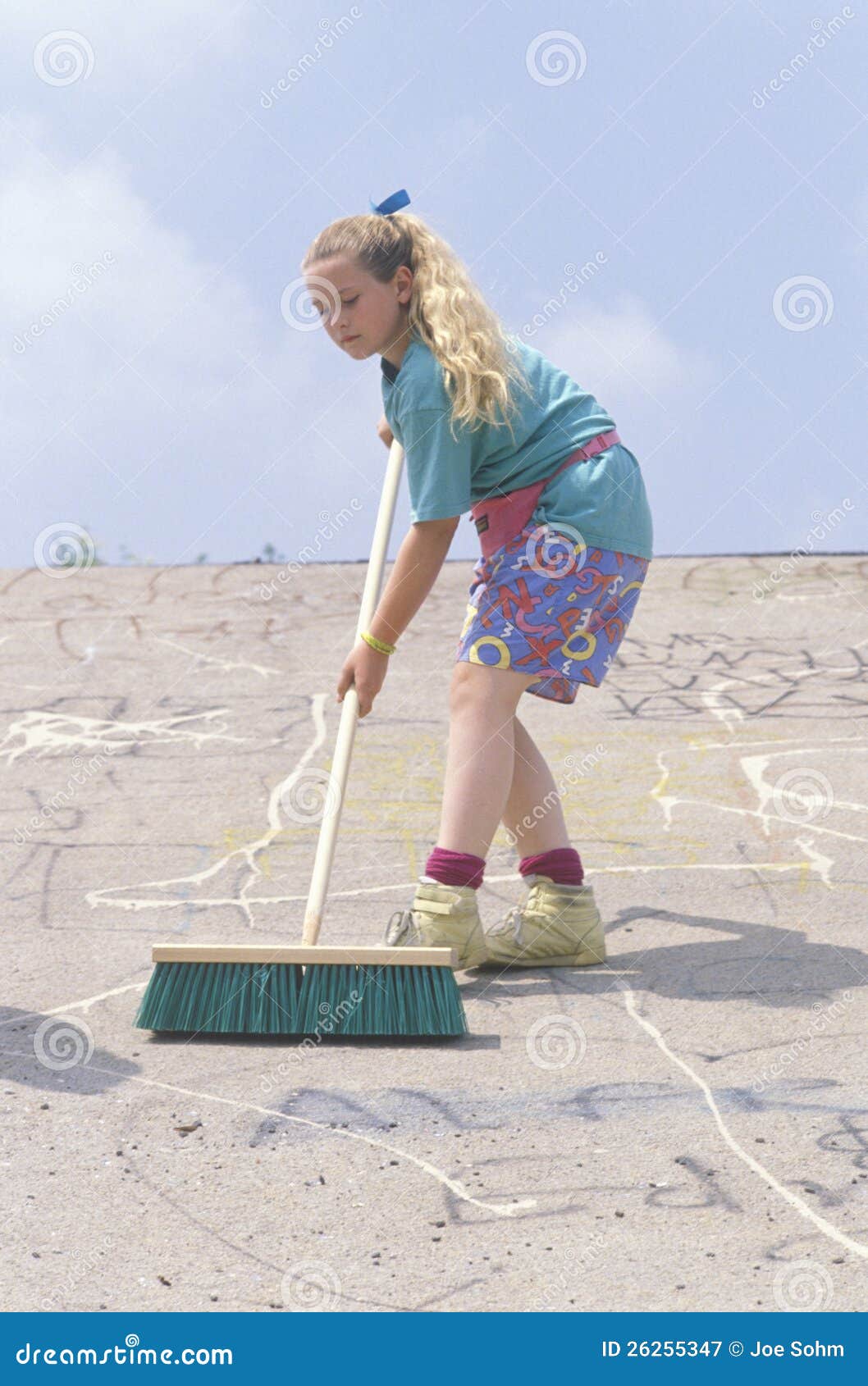 A young girl cleaning up editorial photography. Image of environment ...