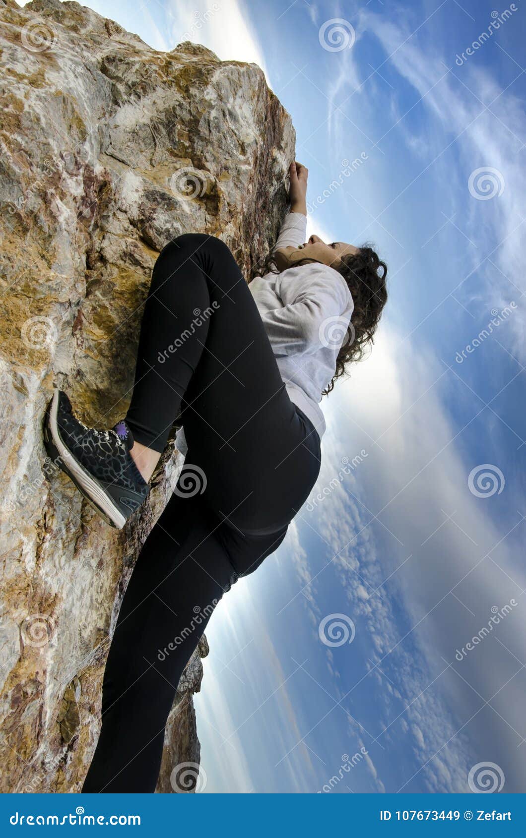 Girl Climbing on a rock stock image. Image of green - 107673449