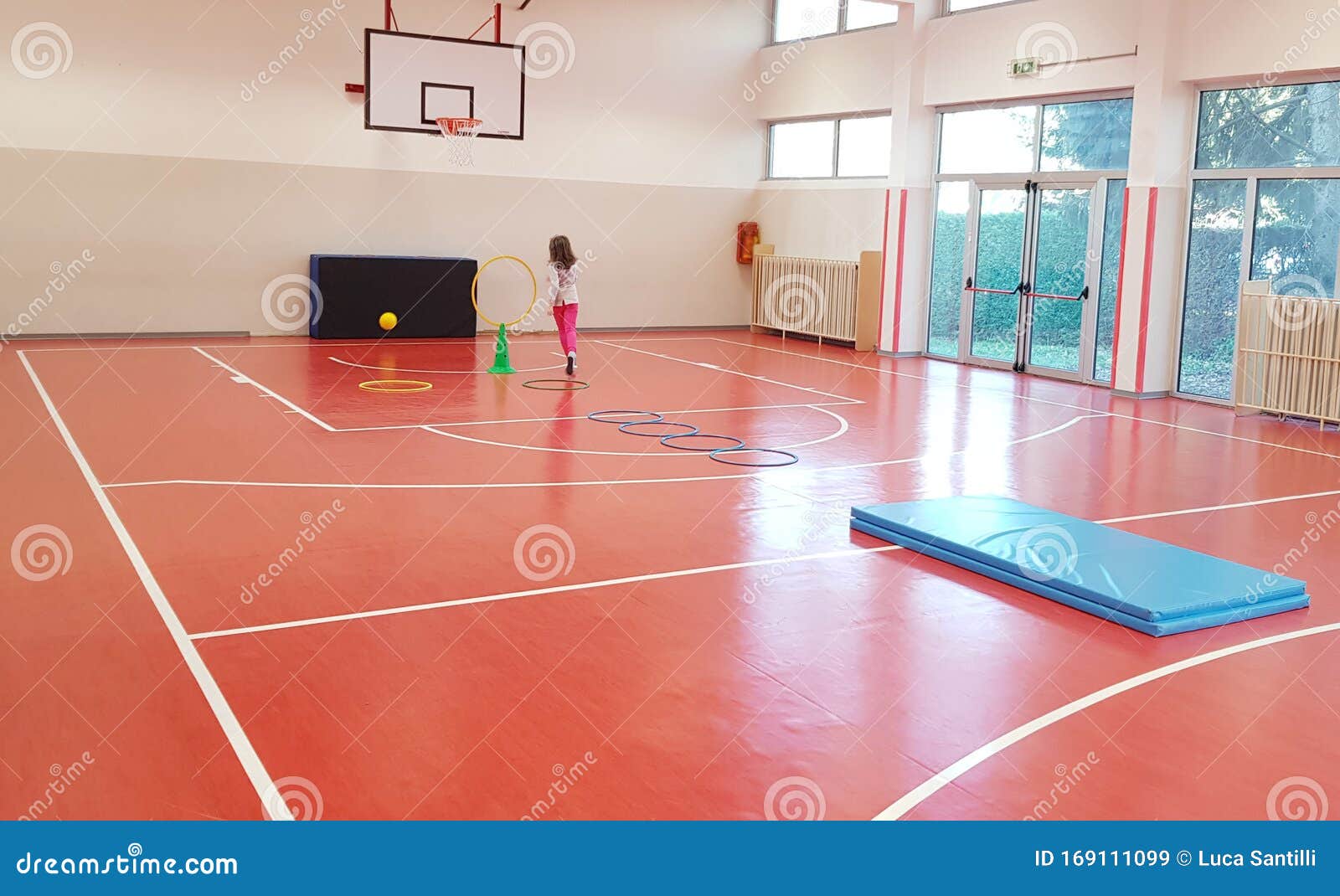 Young Girl is Doing Exercise in a Elementary School Gym Indoor Stock ...