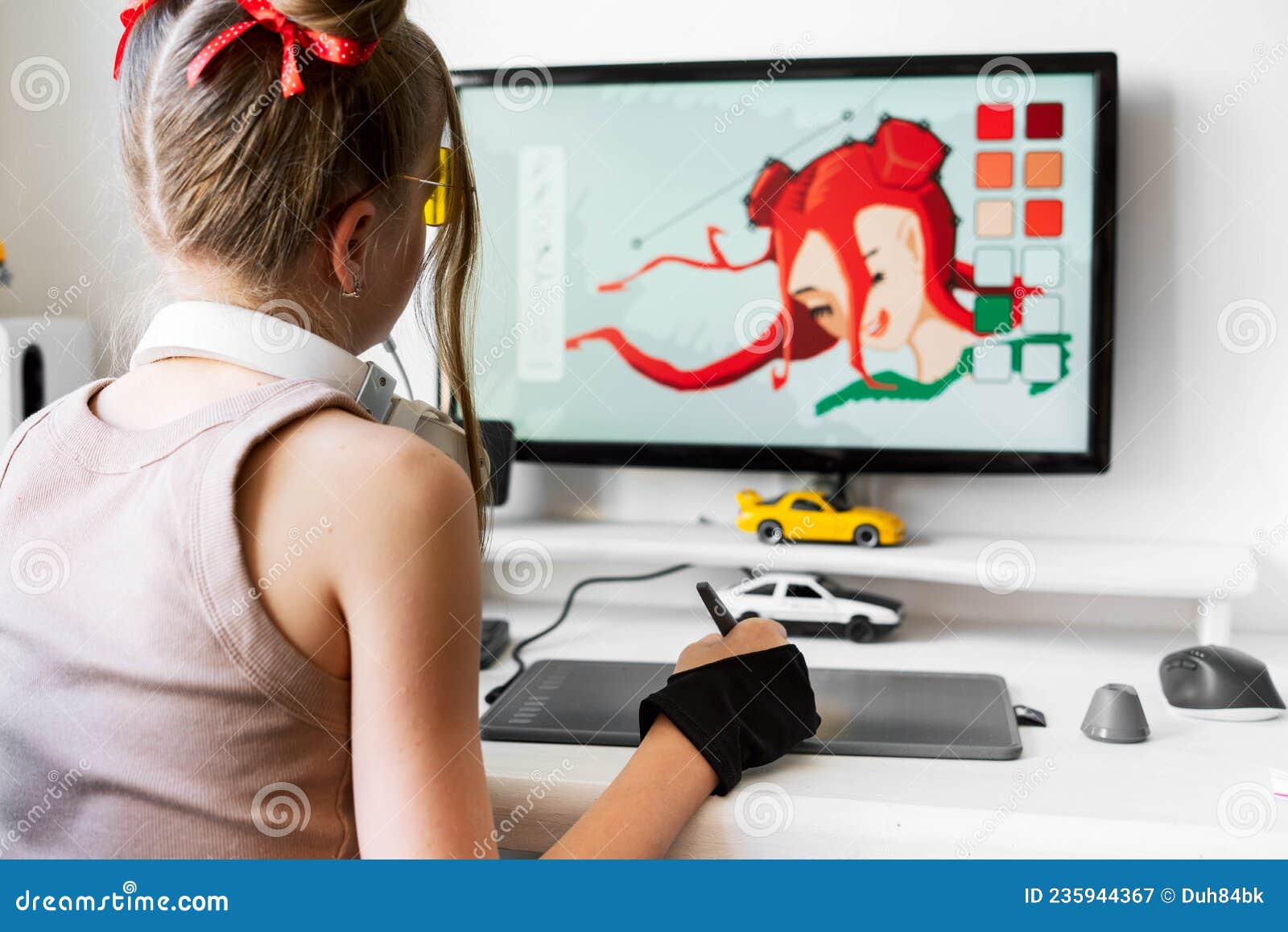 A Young Girl Draws on a PC Using a Graphics Tablet in Her Comfortable ...