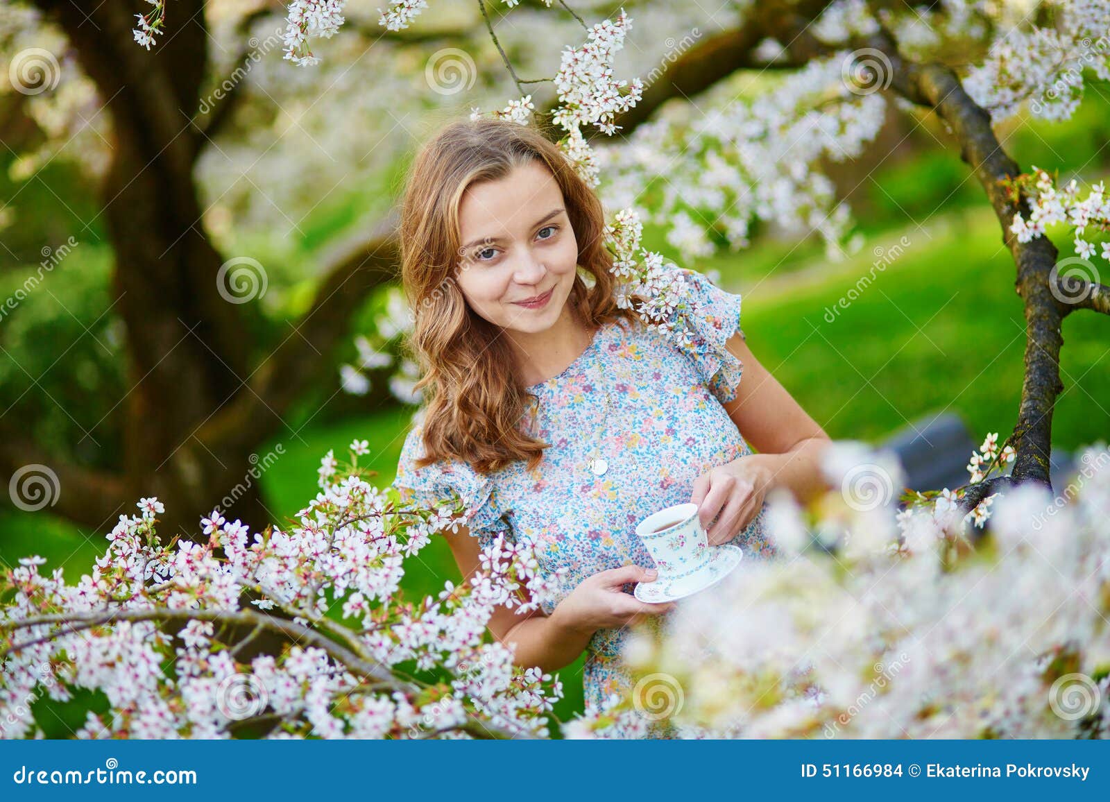 Young Girl Drinking Tea in Cherry Garden Stock Photo - Image of tree ...