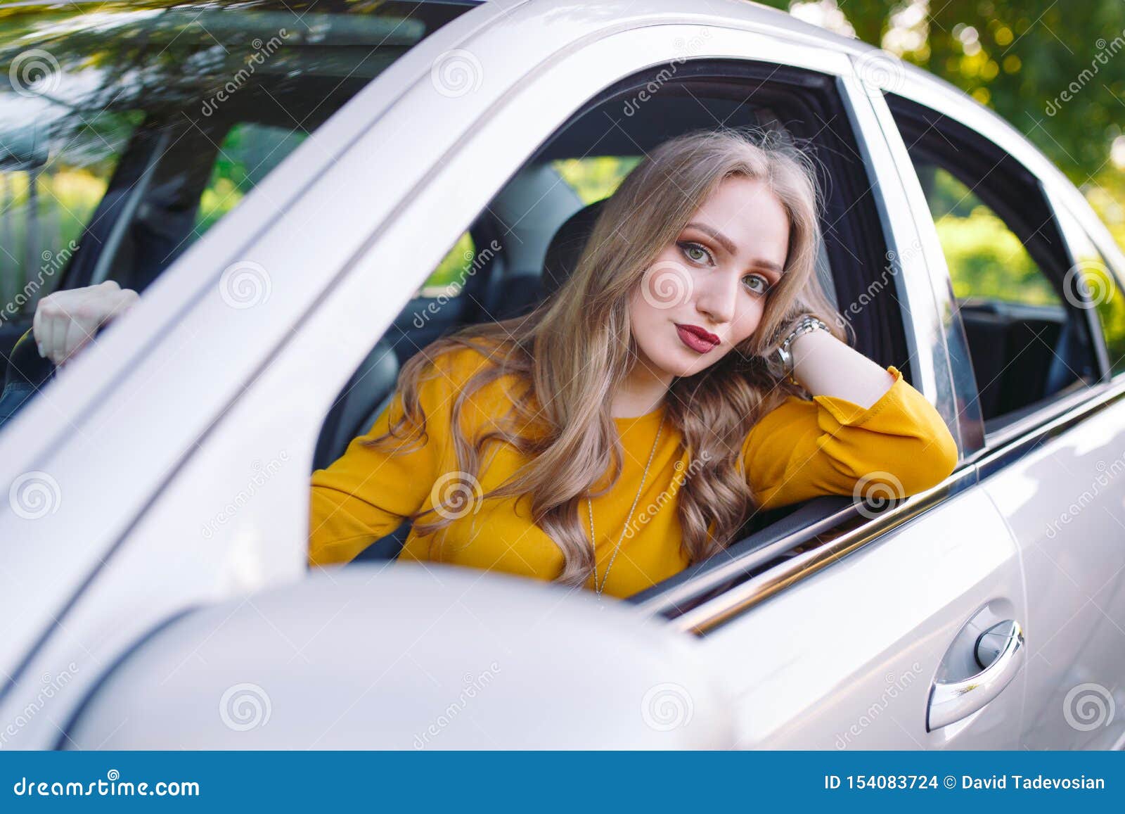 A Young Beautiful Girl is Driving a Car. Stock Photo - Image of ...