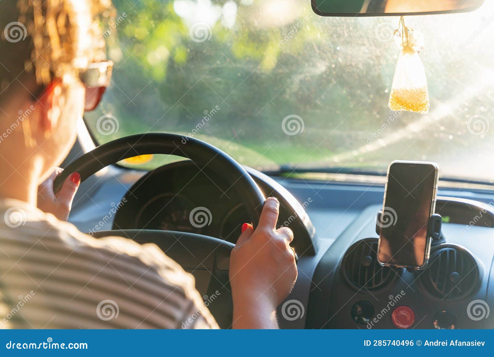 Young Girl Driving a Car while Driving, Rear View Stock Photo - Image ...