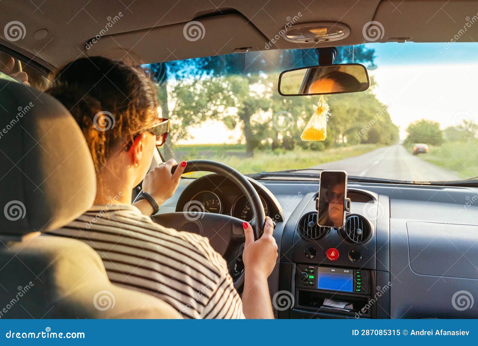 Young Girl Driving a Car while Driving, Rear View Stock Image - Image ...