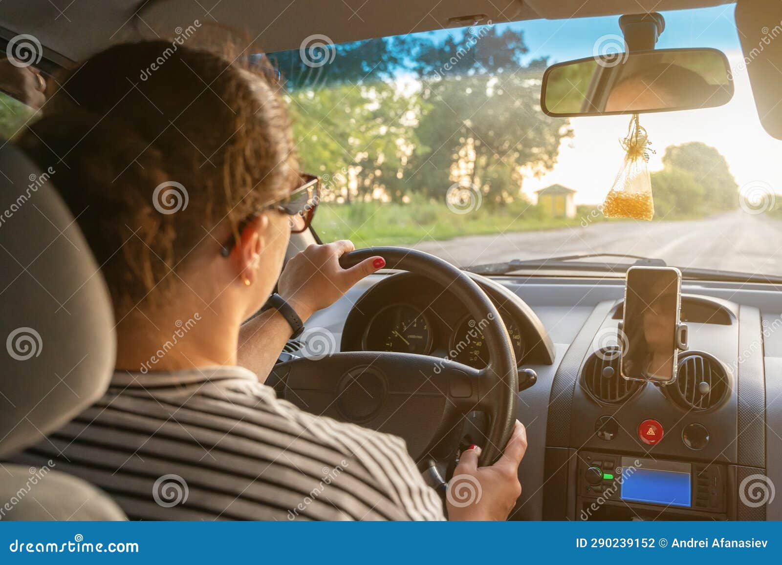 Young Girl Driving a Car while Driving, Rear View Stock Photo - Image ...