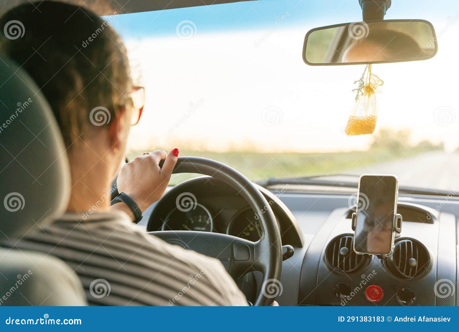 Young Girl Driving a Car while Driving, Rear View Stock Image - Image ...