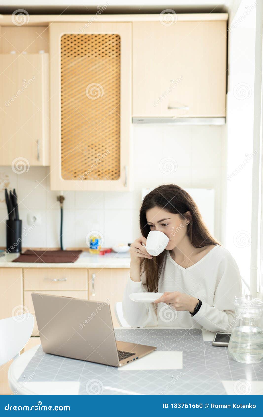 Young Girl E-learning with Laptop and Drink Coffee in Kitchen Stock ...