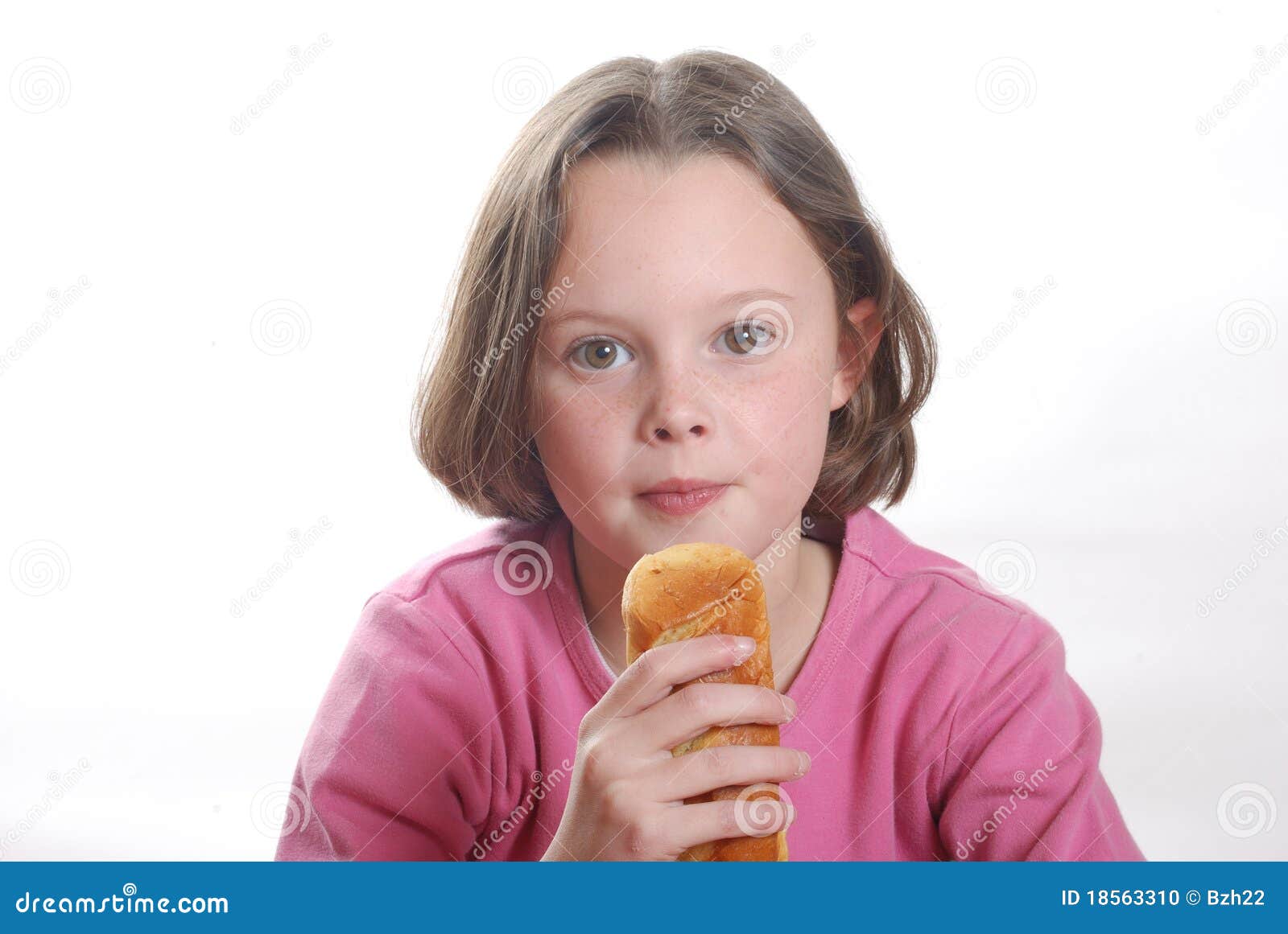Young girl eating a bun stock photo. Image of hunger - 18563310