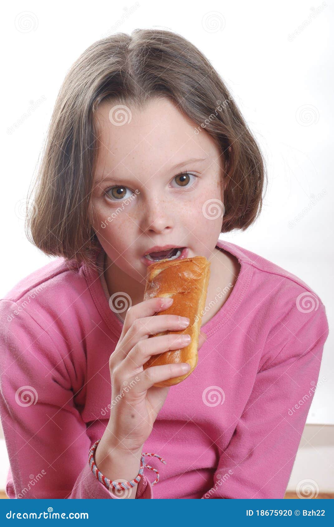 Young girl eating a bun stock photo. Image of child, muffin - 18675920