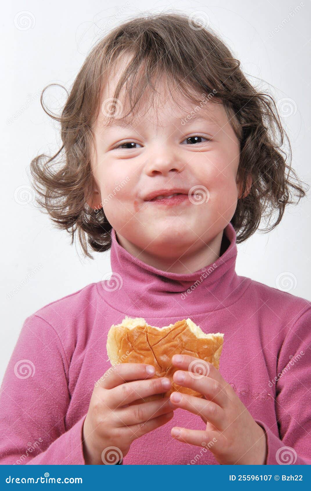 Young girl eating a bun stock image. Image of nutrition - 25596107