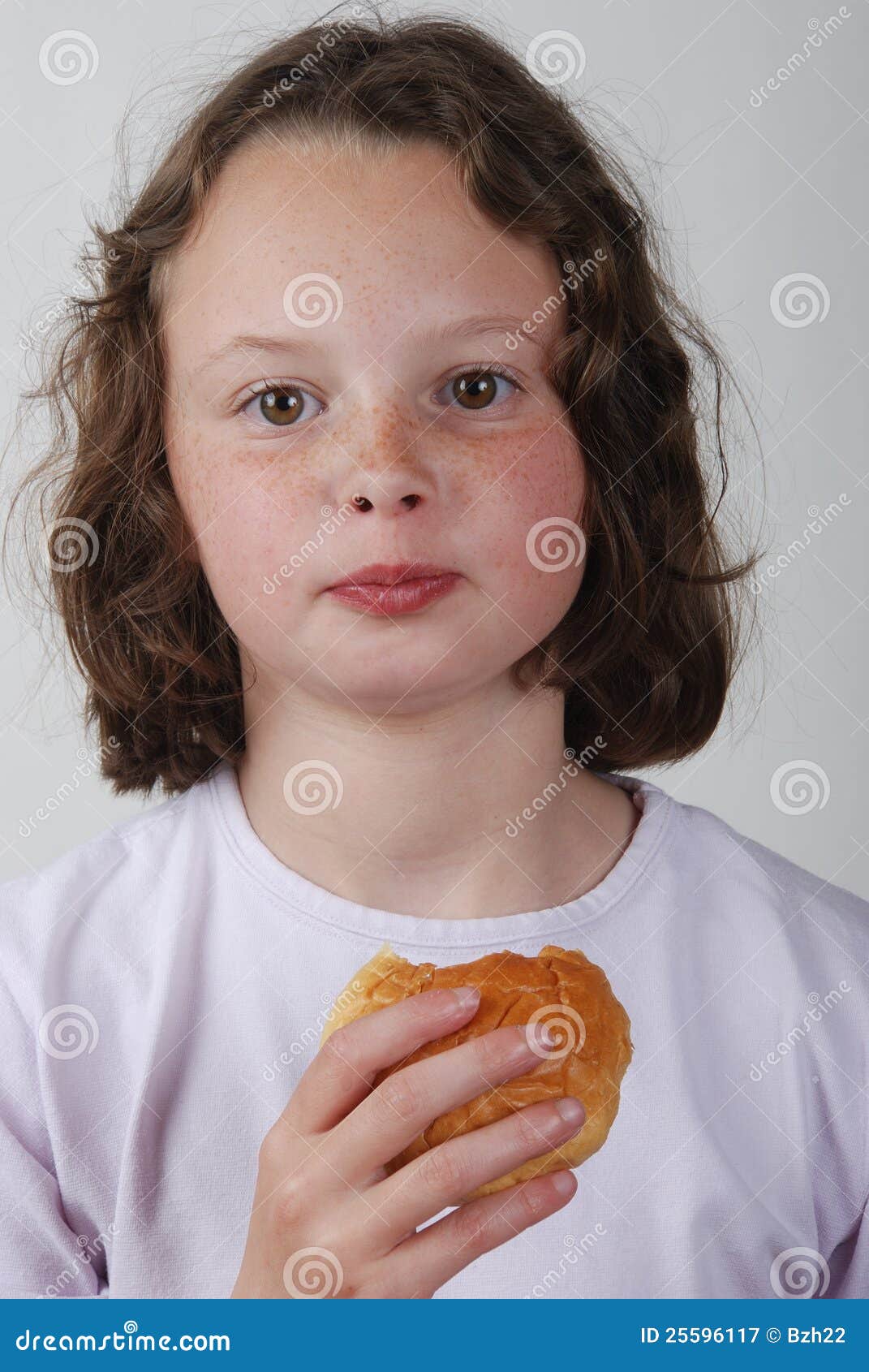 Young girl eating a bun stock image. Image of lifestyle - 25596117