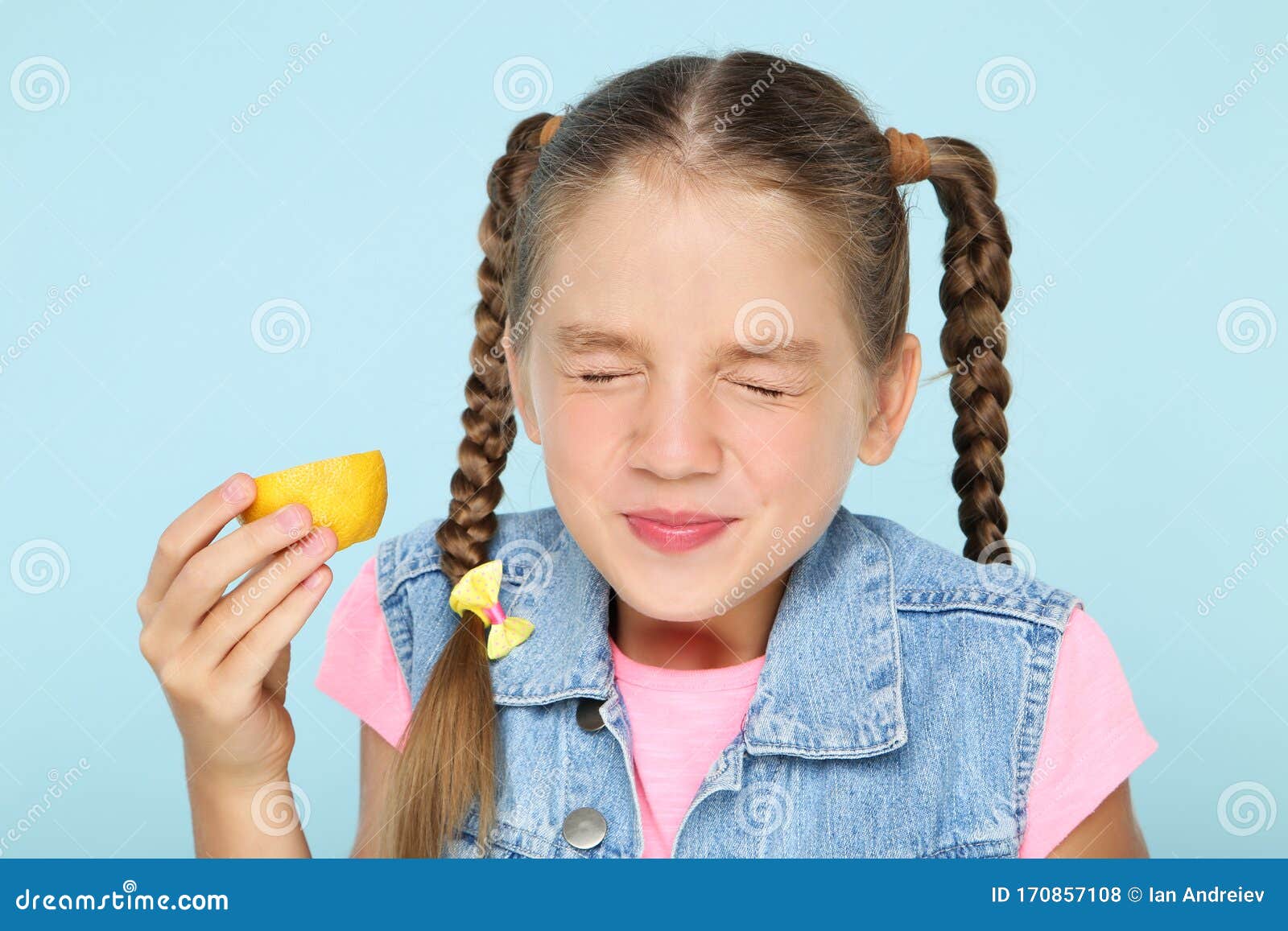 Young Girl Eating Lemon Fruit Stock Photo - Image of holding ...