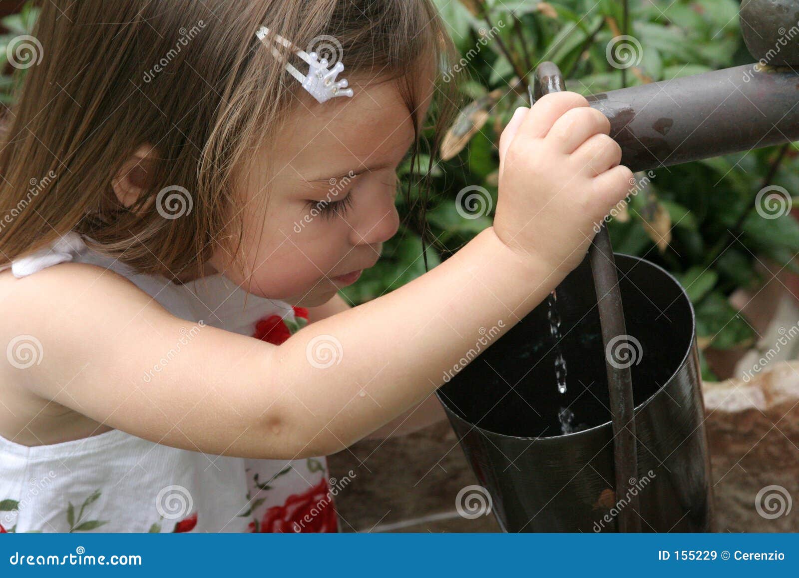 Young girl filling bucket stock image. Image of enjoying - 155229