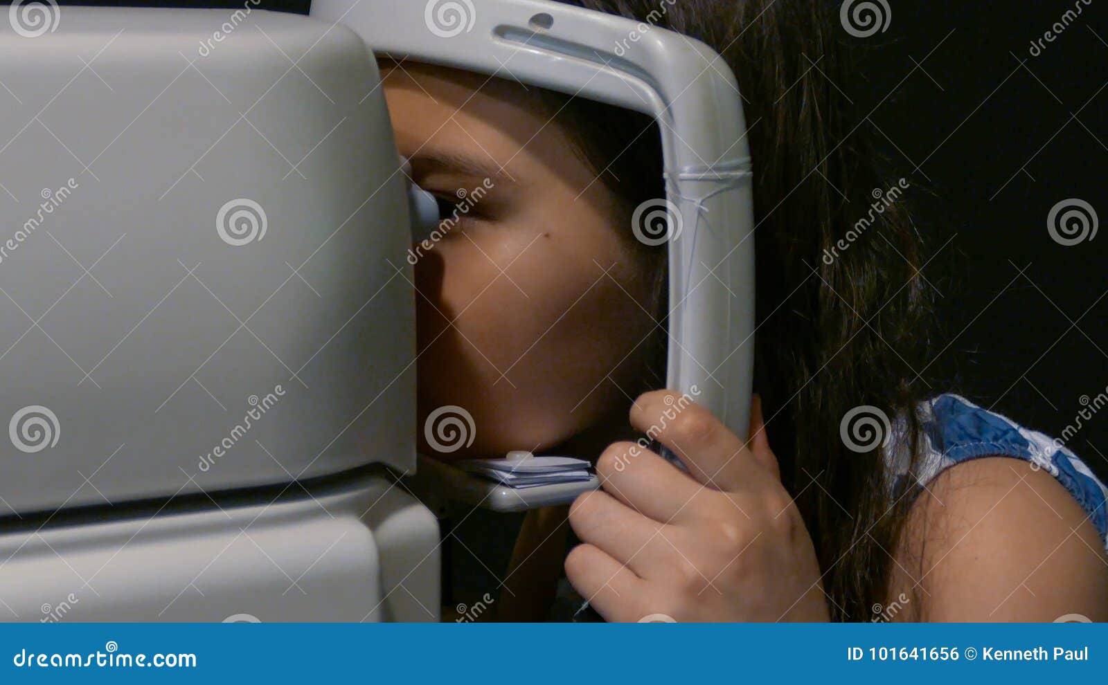 Girl getting eyes tested stock photo. Image of examination - 101641656