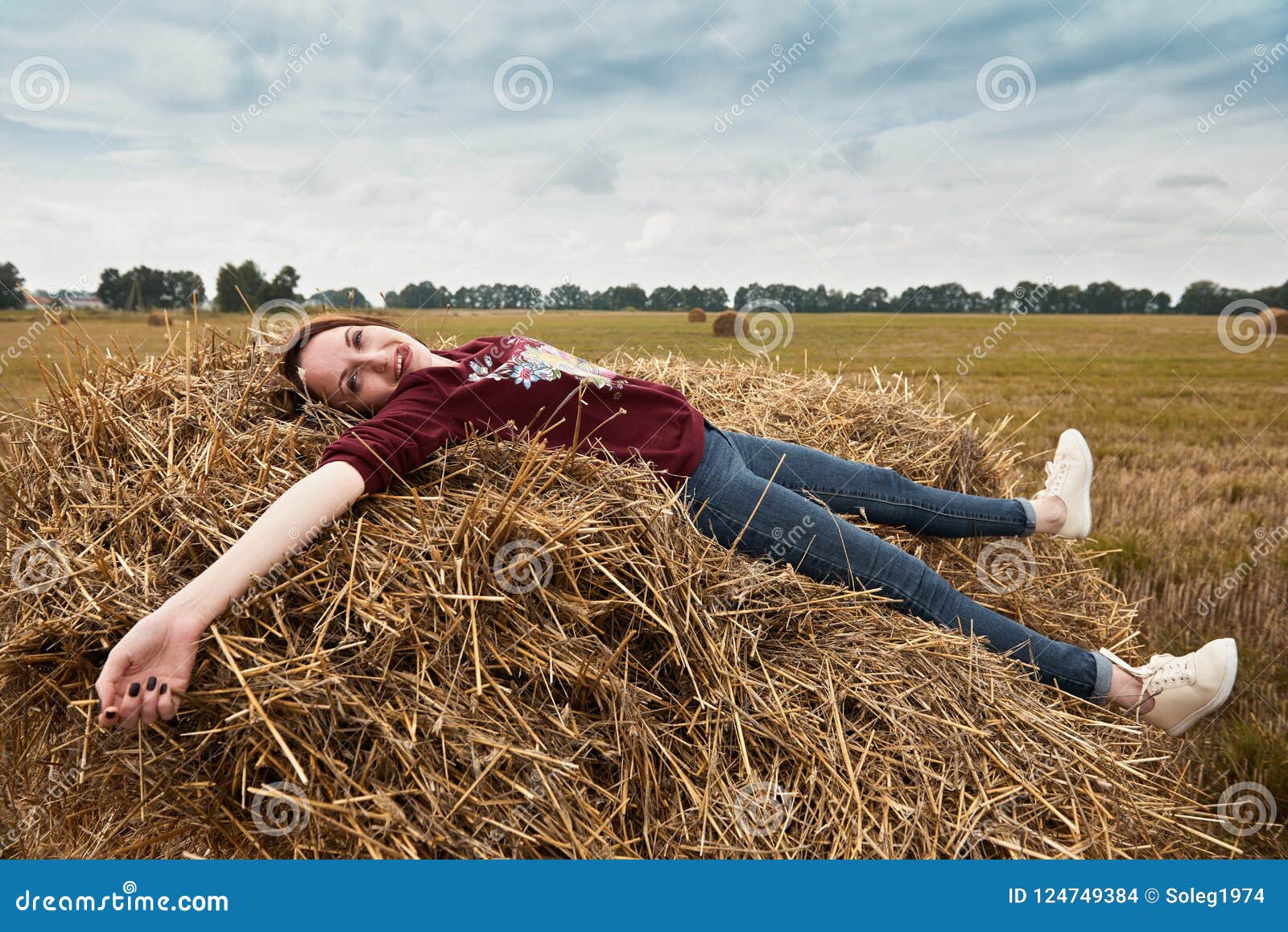 Young Girl Having Fun in the Field, Lying on a Haystack Stock Photo ...