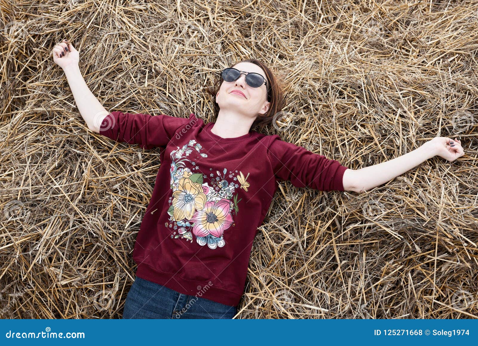 Young Girl Having Fun in the Field, Lying on a Haystack Stock Photo ...