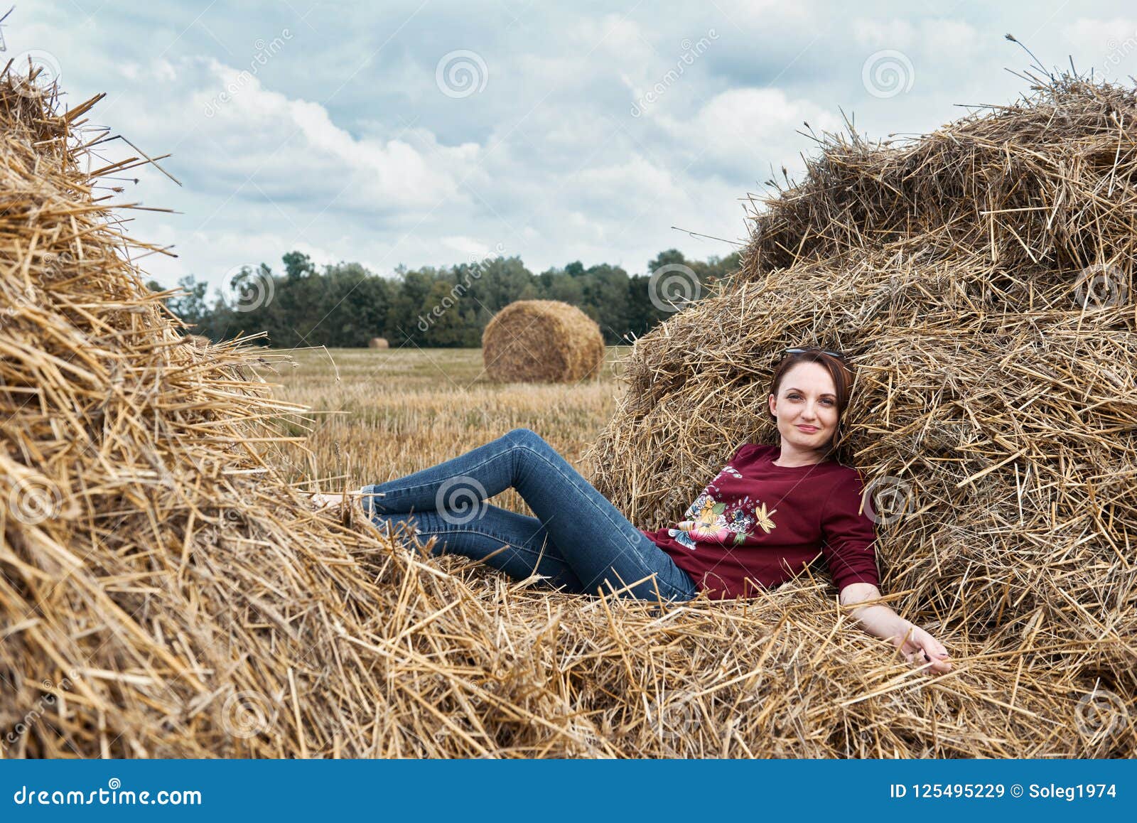 Young Girl Having Fun in the Field, Lying on a Haystack Stock Image ...